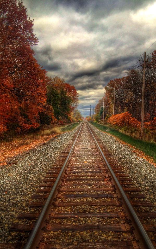 Awesome autumn: Clouds hover above train tracks on a fall day in ...