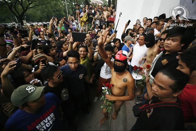 Alpha phi omega holding roses as they participate in annual oblation ...