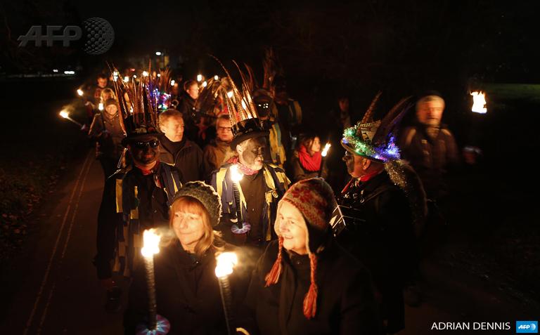 People enter the local orchard during the annual Wassail night in ...