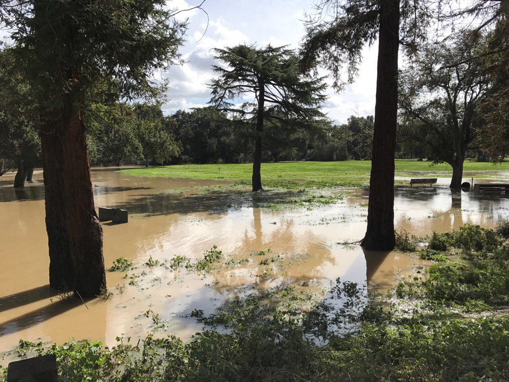 Park benches are islands in this grassy field swallowed up by a swollen ...