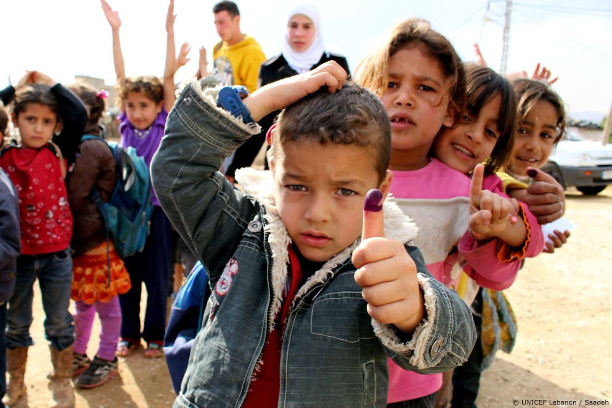 Children in Lebanon show off their painted fingers after receiving ...