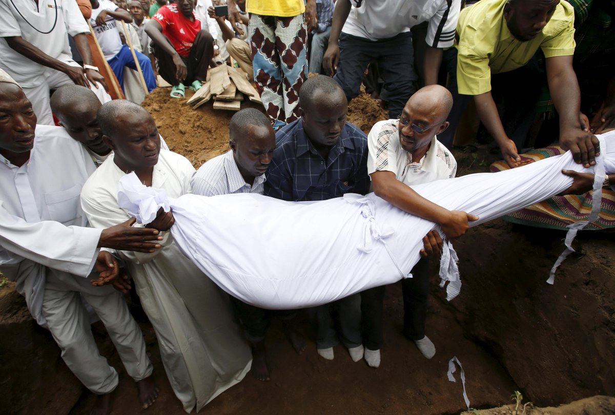 Men carry the body of Zedi Feruzi, the head of opposition party UPD ...