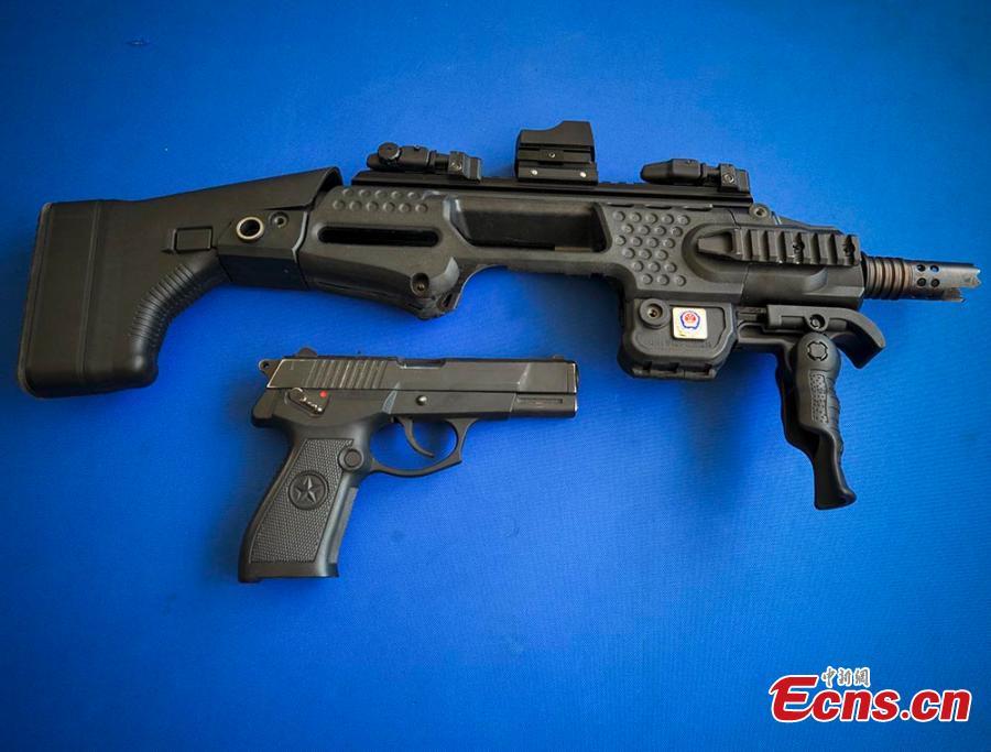 Police try newly developed gun support for qsz-92 pistol in urumqi city ...