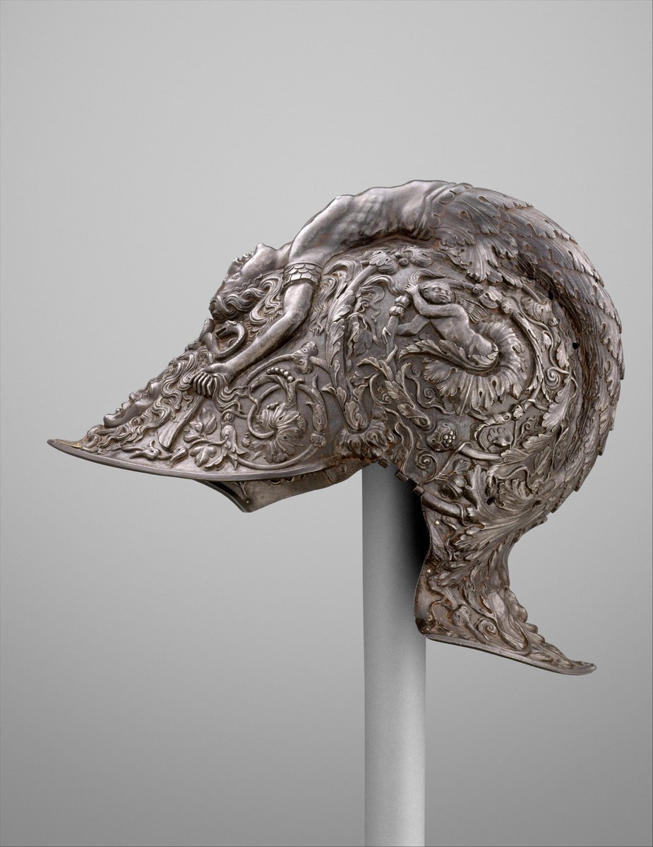 The mermaid-like siren on this 16th-century helmet holds the head of ...
