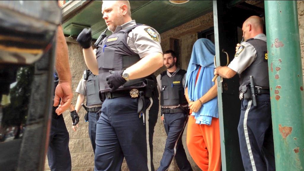 Jimmy Melvin Jr had his head covered with a blanket as he was led from ...