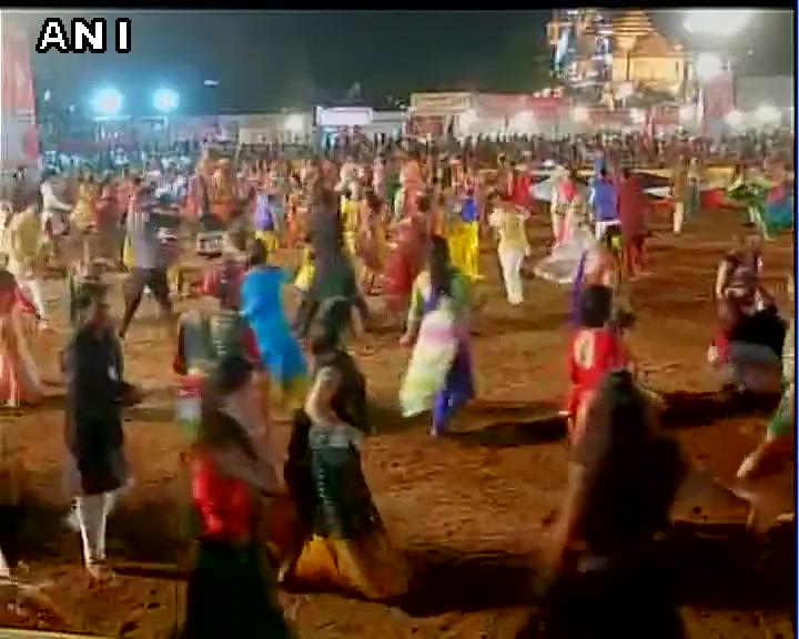 Women and men dance to the tune of traditional garba songs at a Garba ...