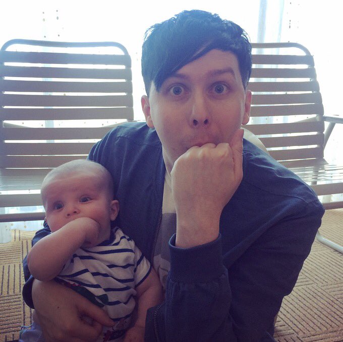 Phil Lester Holding A Baby