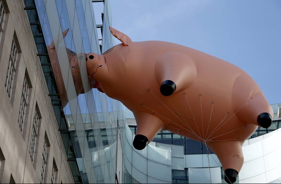 An inflatable pig is spotted outside the BBC's headquarters in London ...