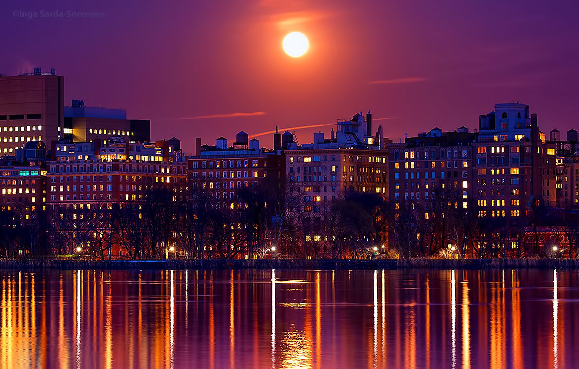Stunning shot of a full moon at twilight over new york city ...