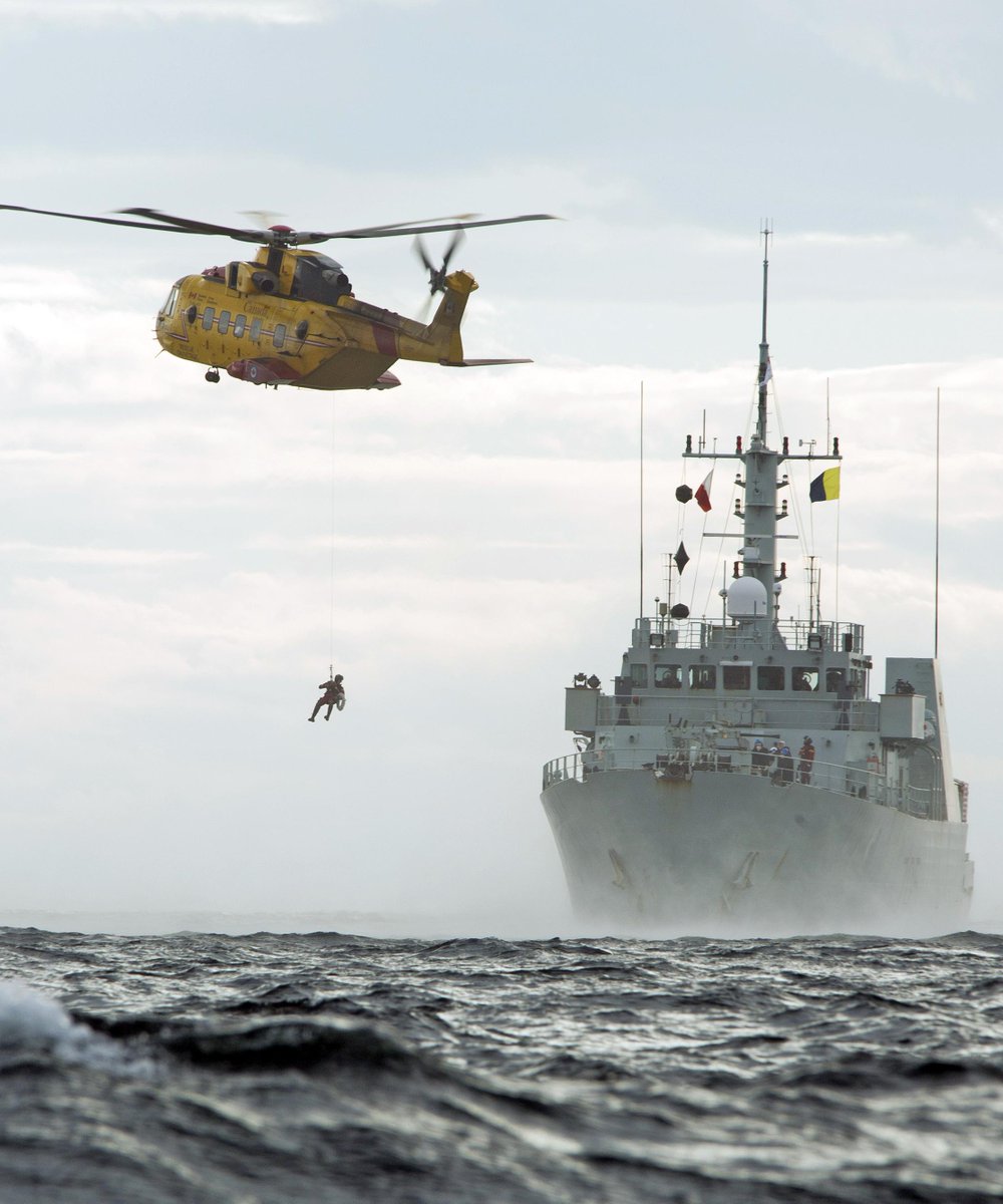 442 Sqn crew in a CH-149 Cormorant conduct a vertical transfer of ...