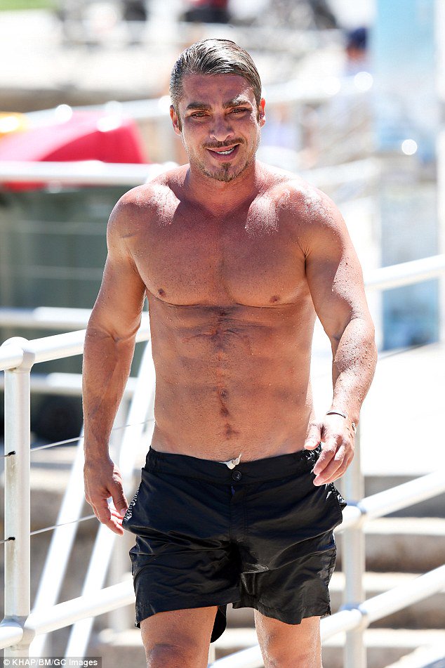 John ibrahim cools off at bondi beach showing off the scar on his ...