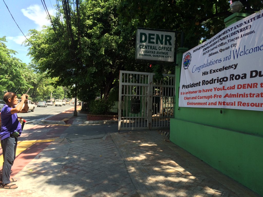 EARLIER: DENR employees hang welcome banner for Duterte at central ...