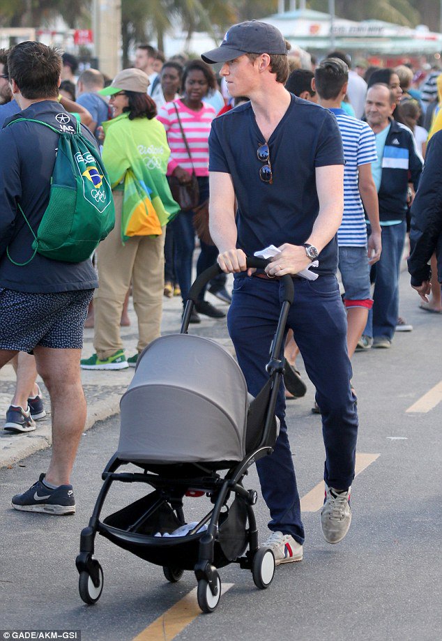 Eddie Redmayne enjoys a walk around the Olympic park with baby Iris ...