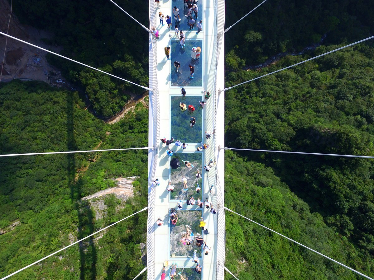 Glass bridge hanging 300m above a valley in Zhangjiajie in south China ...