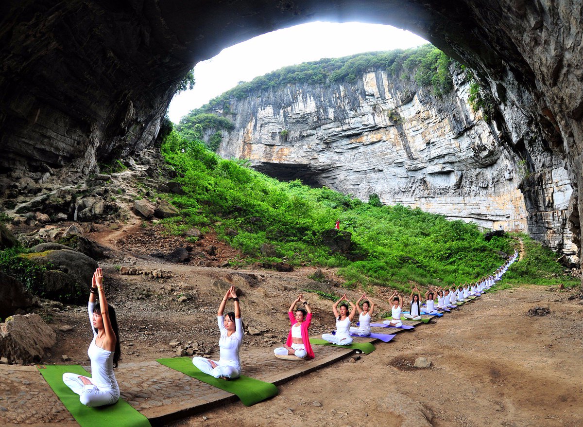 yoga lovers practice their poses surrounded by nature on Sunday in ...