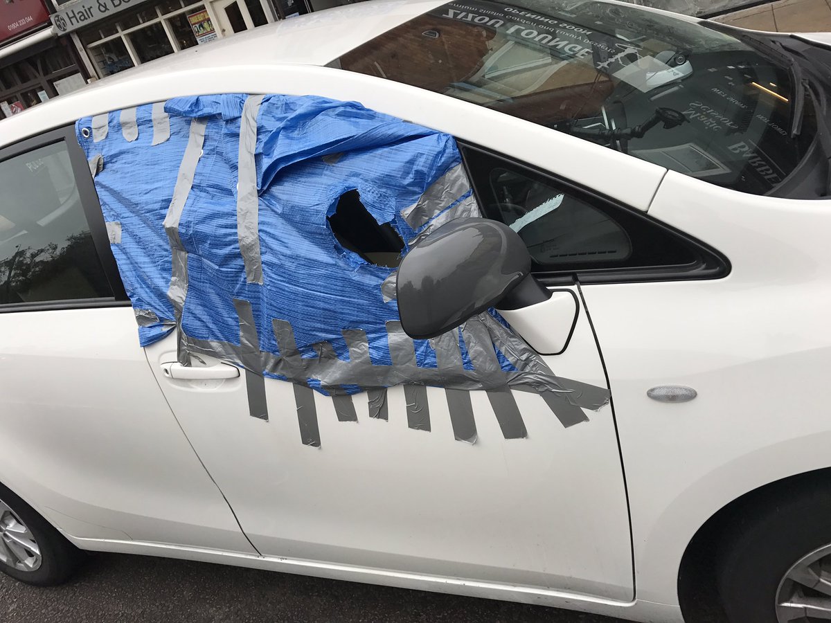 Driver patched-up window with blue sheet - but left a hole so he could ...