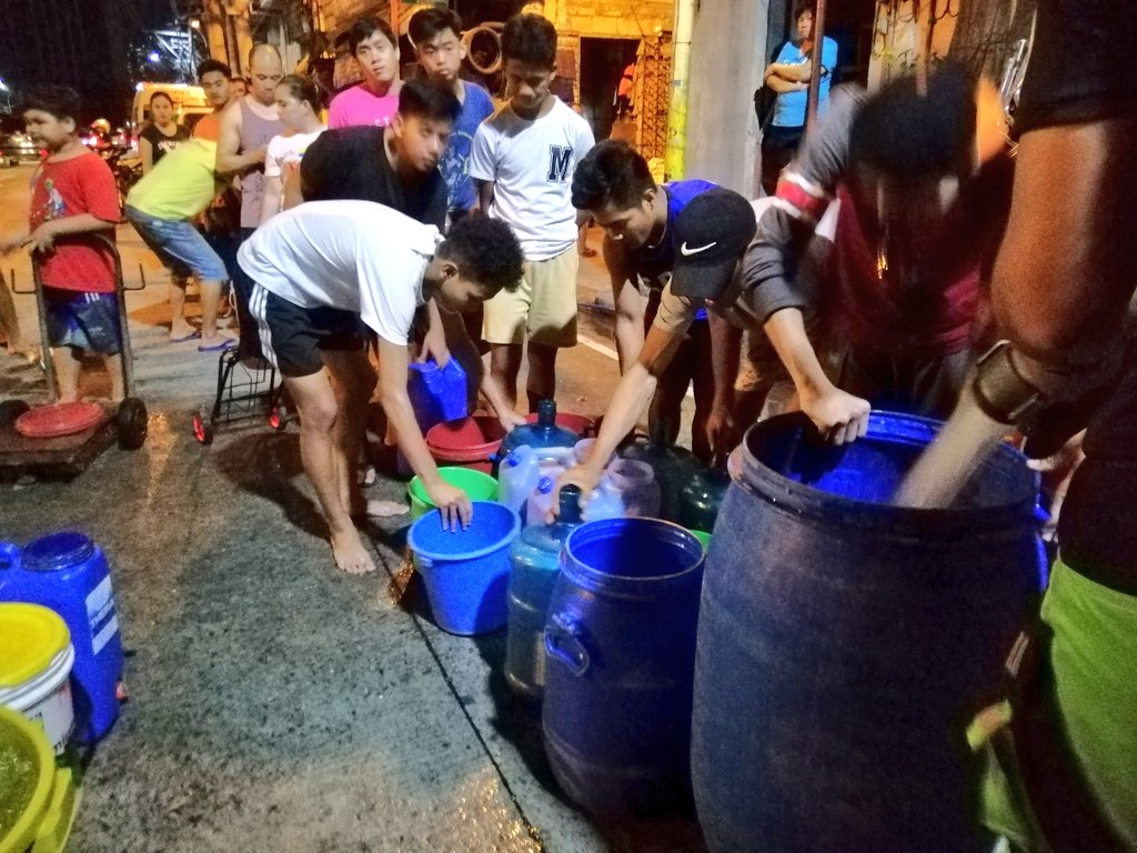 LOOK: Residents at Barangay Hulo, Mandaluyong City line up near a fire ...