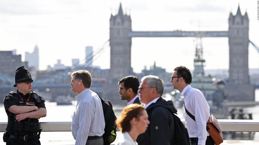 Commuters walk across a reopened London Bridge as extra security is ...