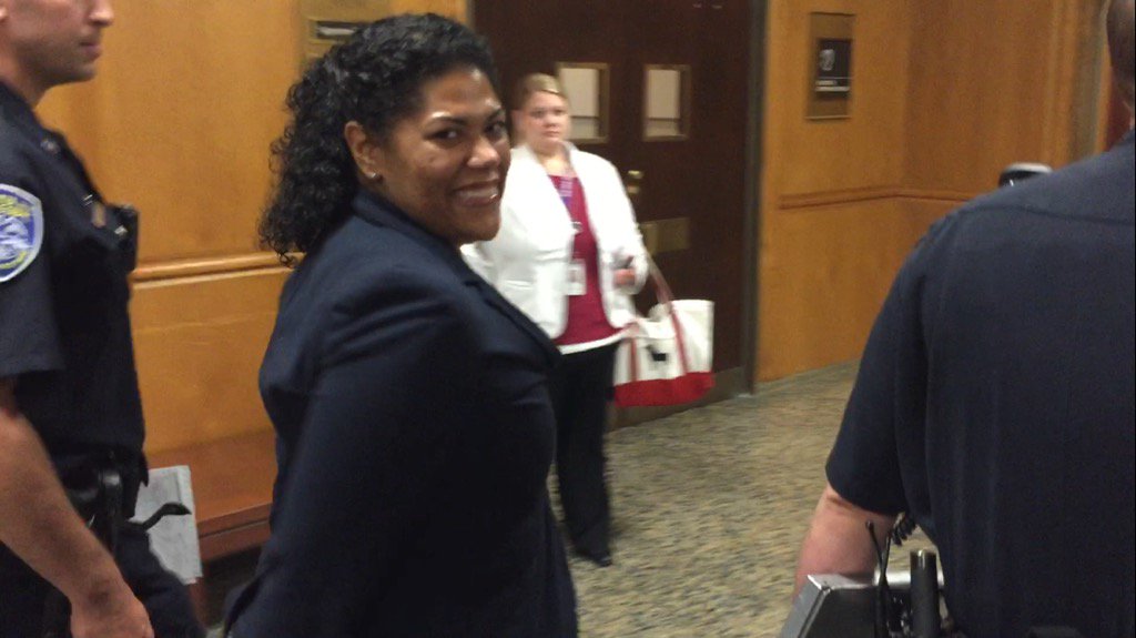 Judge Leticia Astacio being escorted out of chambers in handcuffs as I ...