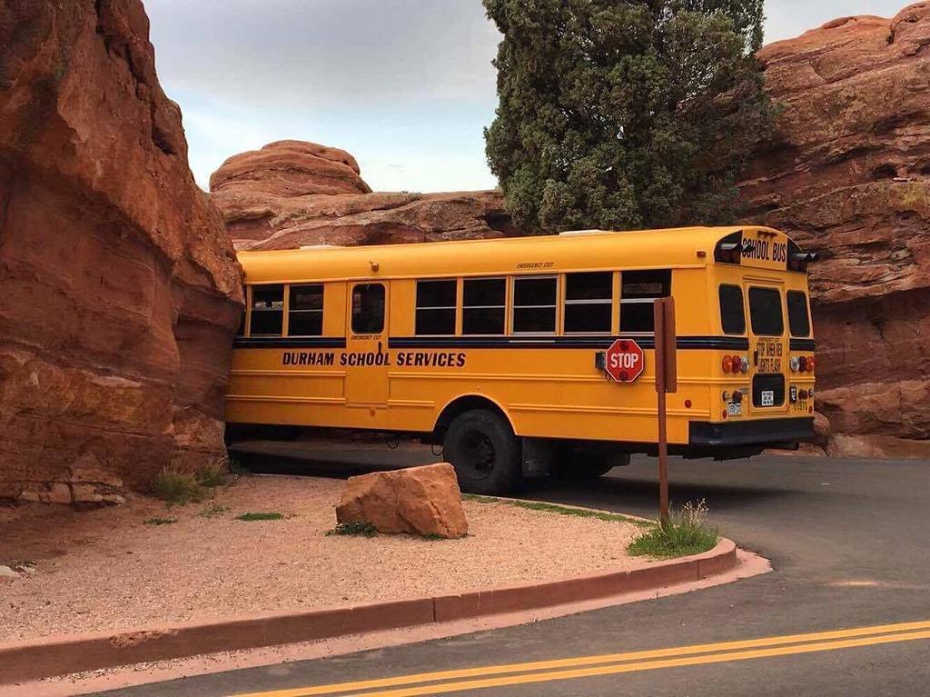 Uh oh. A school bus got stuck between a rock and... another rock at ...