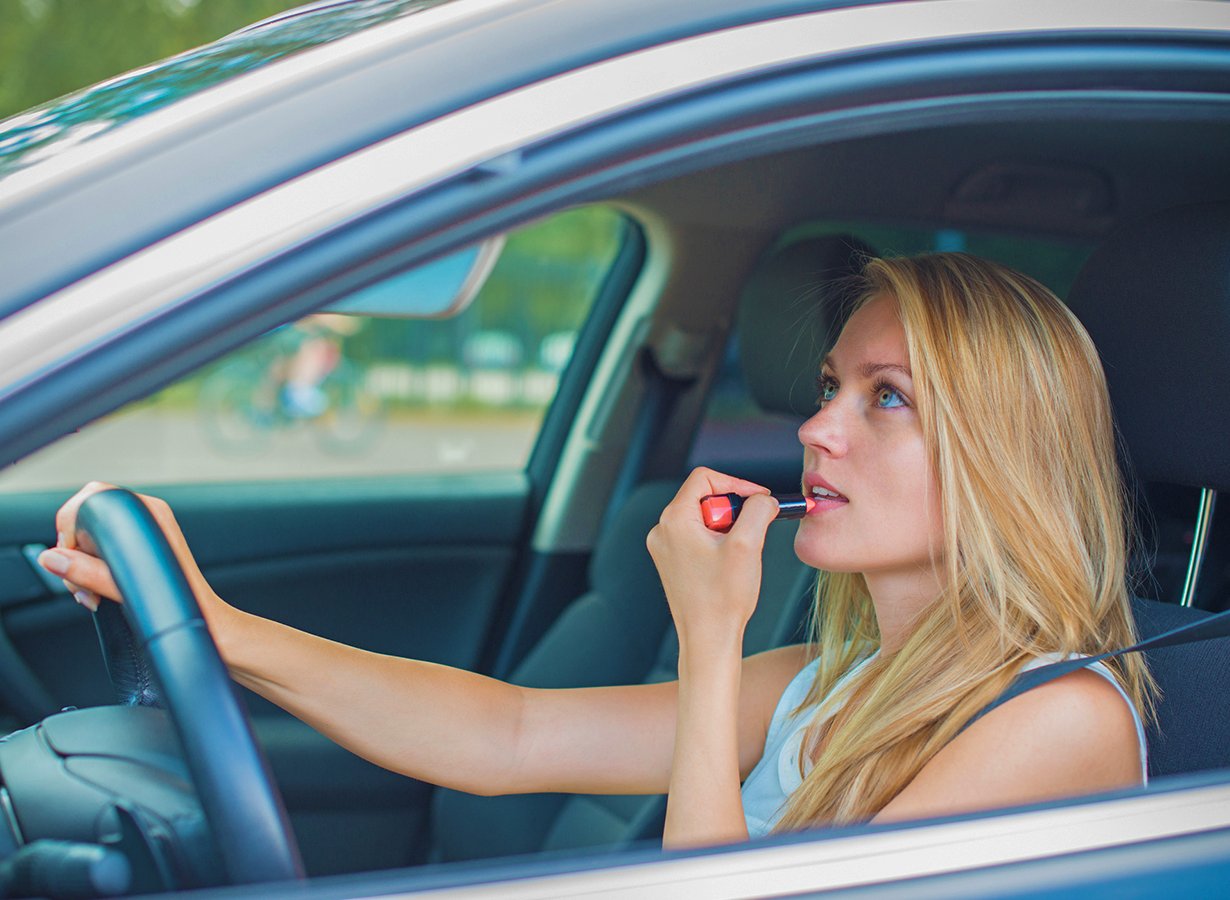Woman Putting On Makeup While Driving