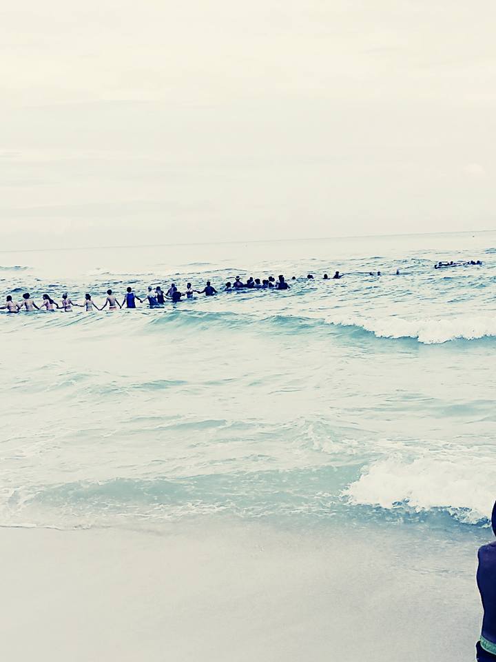 After around a dozen people were swept out by a riptide, beachgoers at ...