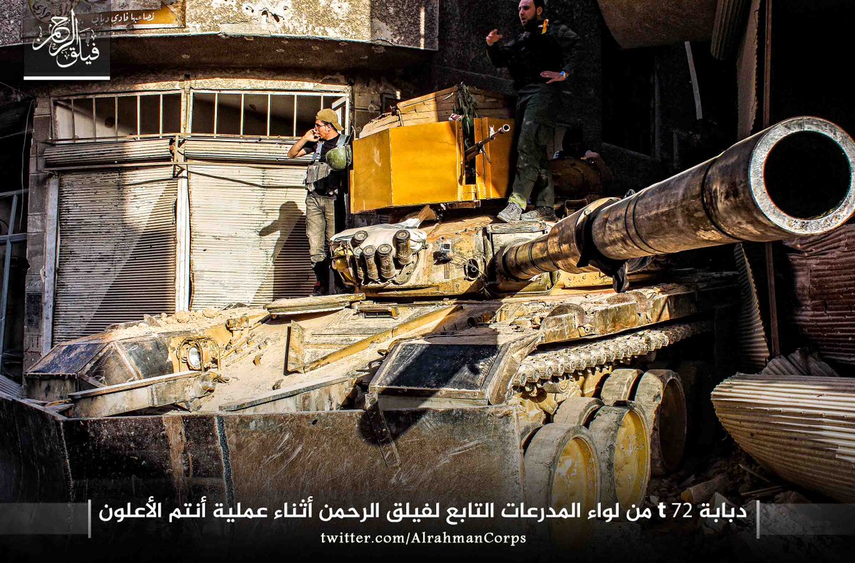 T-72M1 fitted with a dozer blade, partial slat armor with sandbags ...