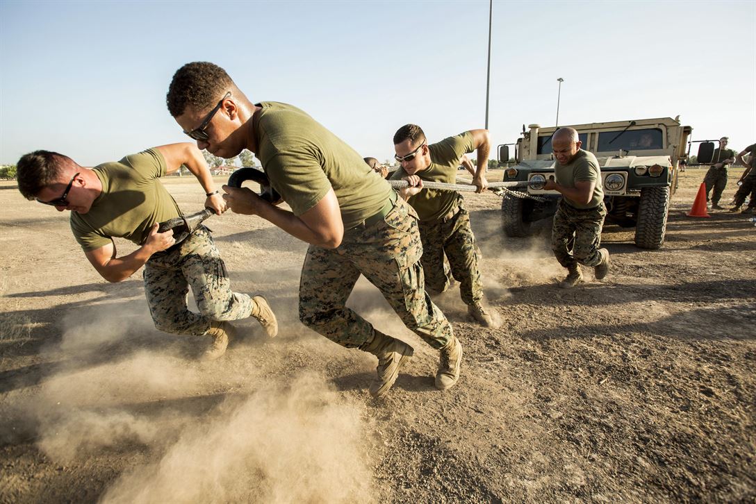 All in a day’s work! Marines pull a Humvee during a field meet between ...