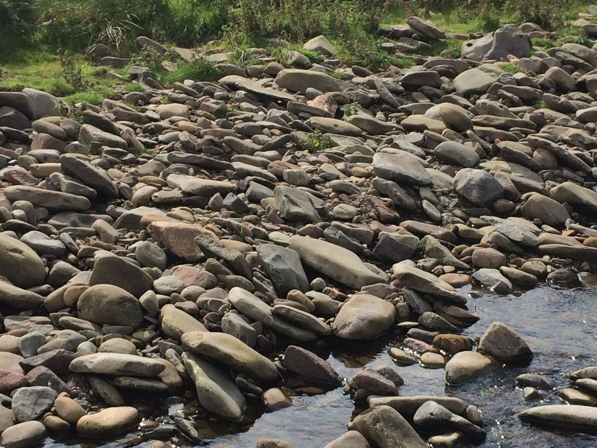 Stones placed on their sides so they give the illusion of flowing water ...