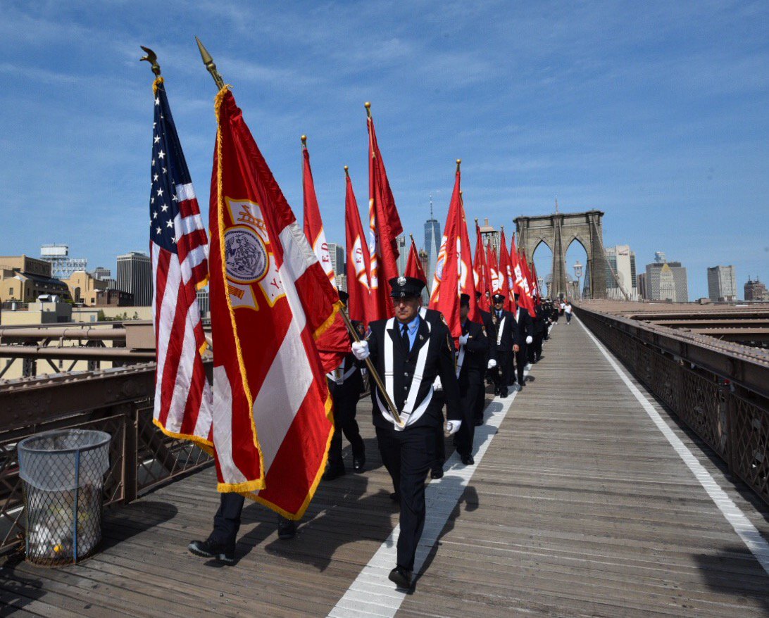 U.S. & FDNY flags are carried across the Brooklyn Bridge by FDNY ...