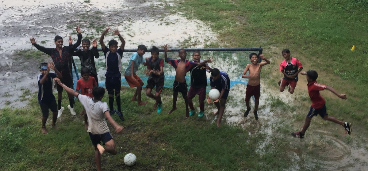 Kids Playing Soccer In The Rain