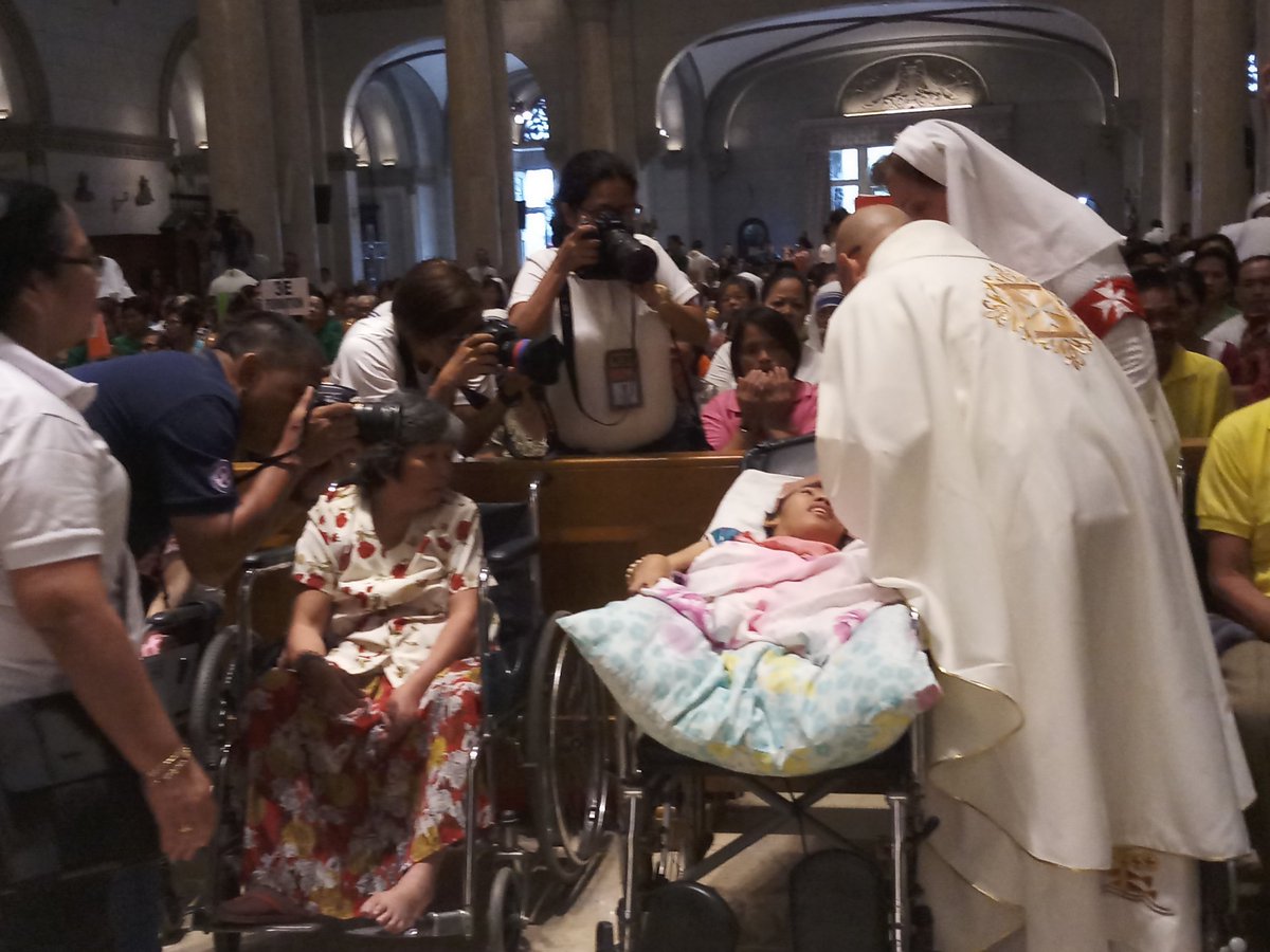 Priests, including lo, going around the manila cathedral to anoint the ...