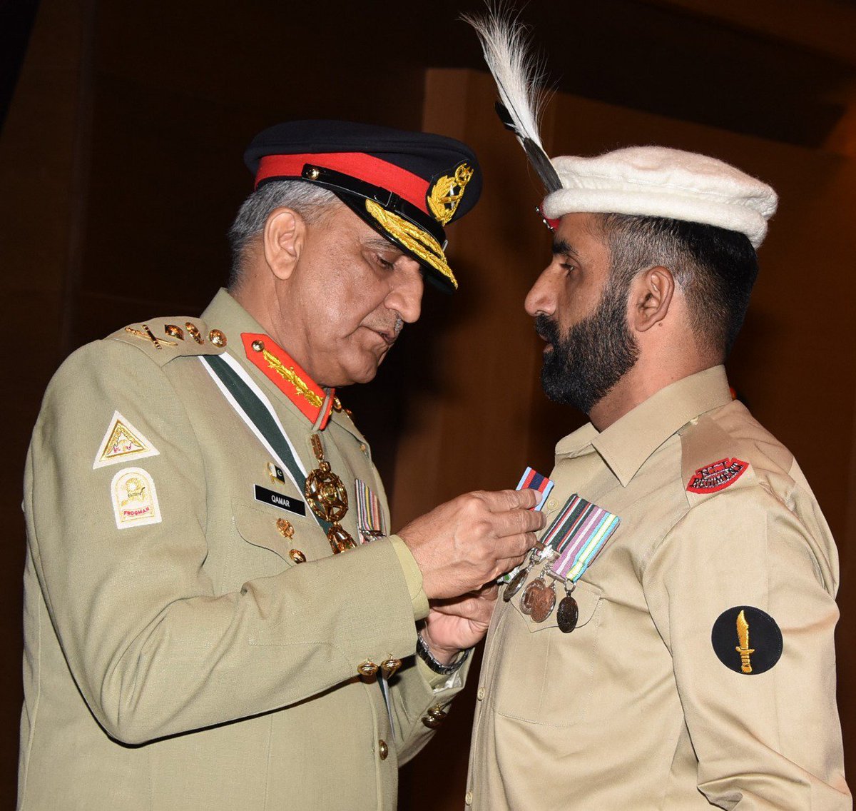 Pakistan Army Chief General Qamar Javed Bajwa awards a soldier from the ...