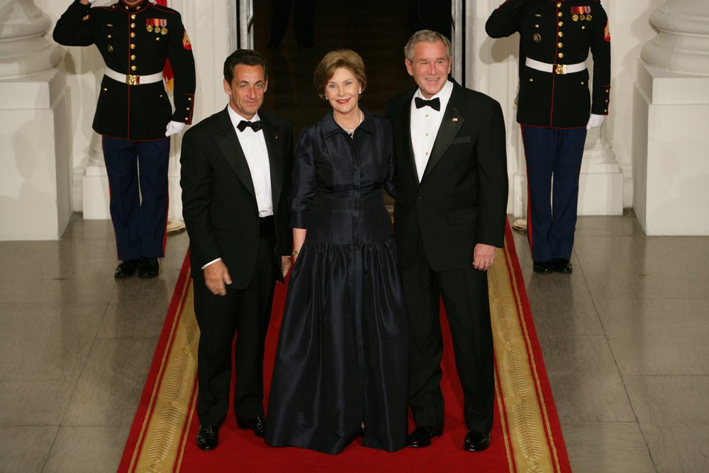 President George W. Bush and First Lady Laura Bush stand with President ...