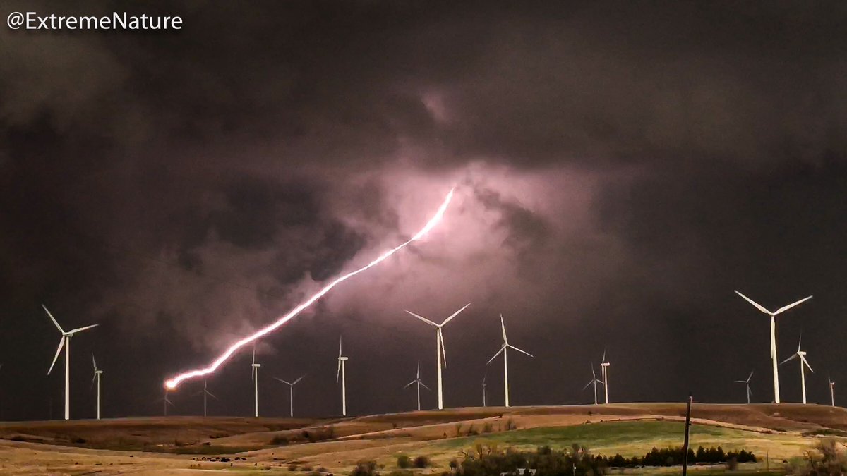 Lightning strikes the blade of a large wind turbine at smokey hills ...