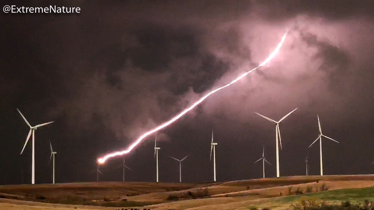 Lightning strikes the blade of a large wind turbine at smokey hills ...