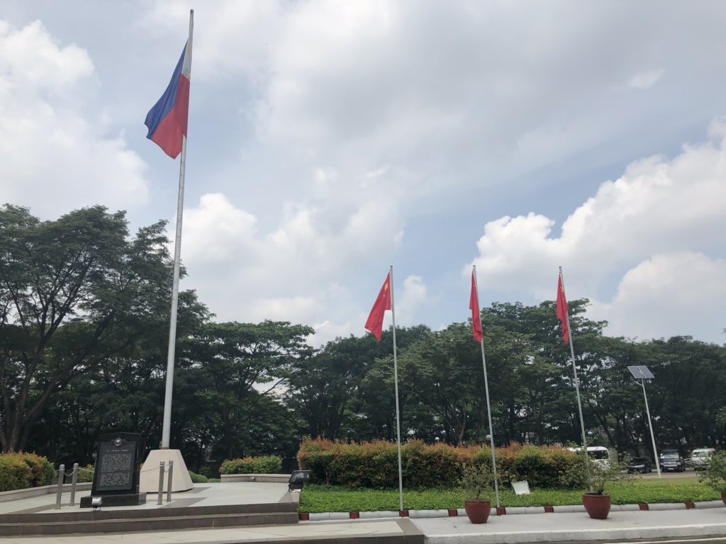 Flags of China fly alongside the Philippine Flag outside the Plenary ...