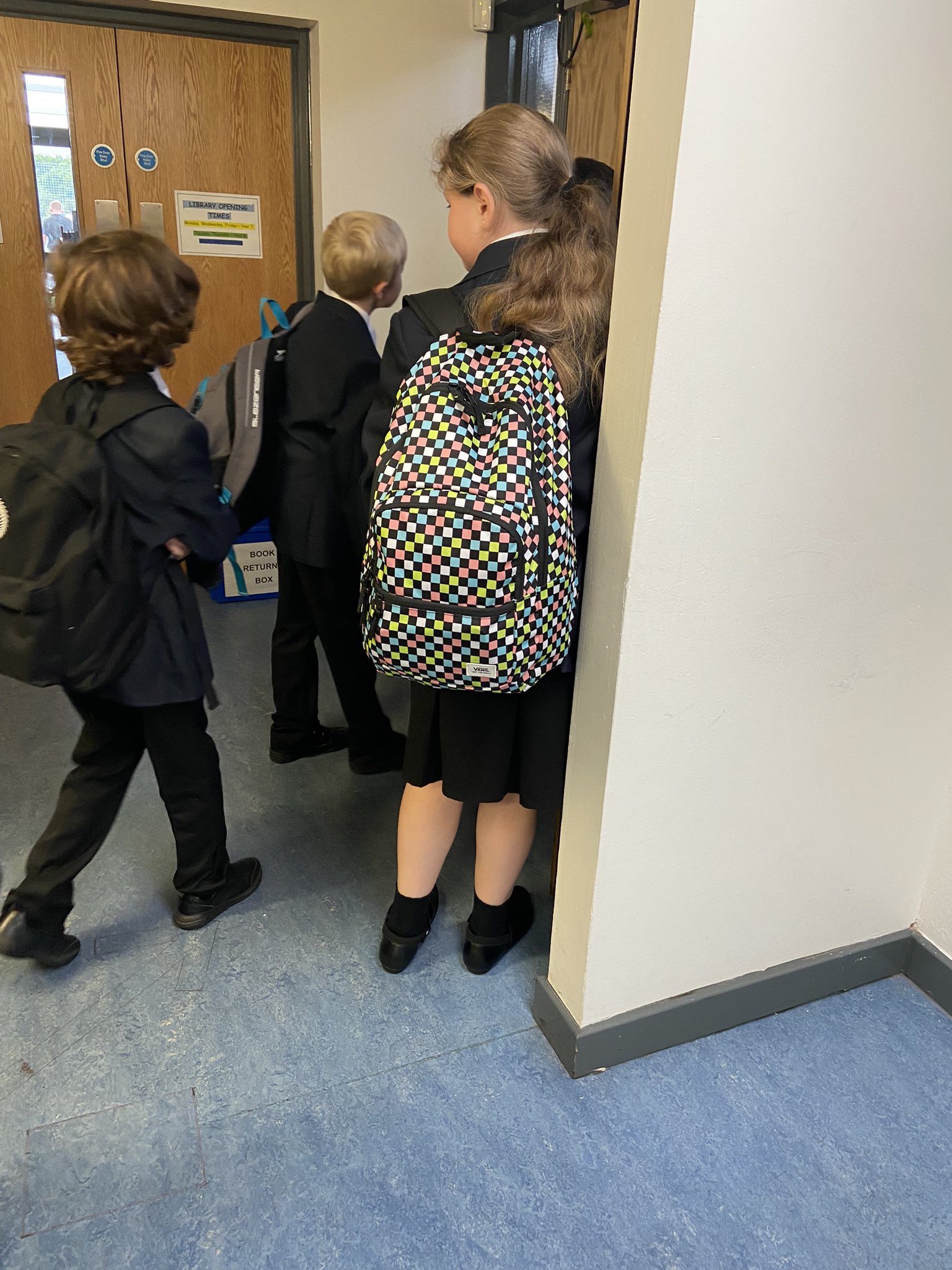 Child Holding Door Open At School