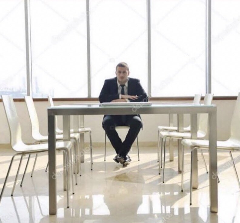 Man Alone At Long Table