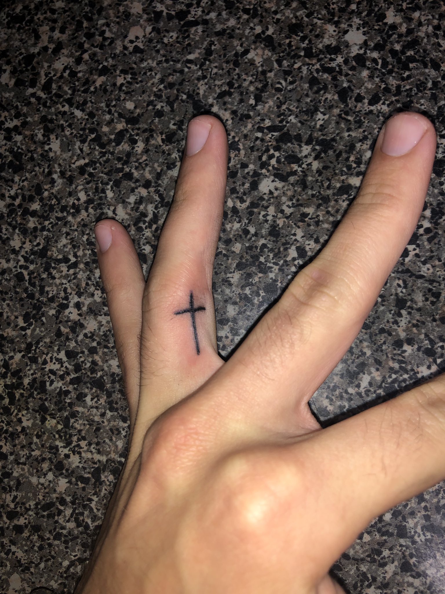 Cross Tattoo On Inside Of Finger