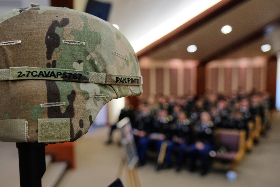 The helmet of Spc. Nicholas Panipinto is displayed on a battlefield ...