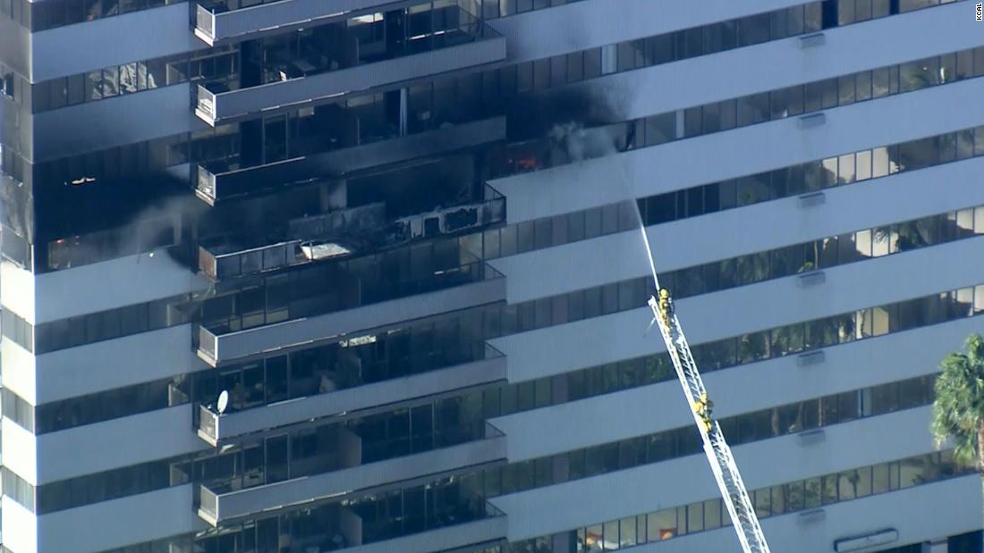 Several people are hurt in a fire that's still burning at a high-rise ...