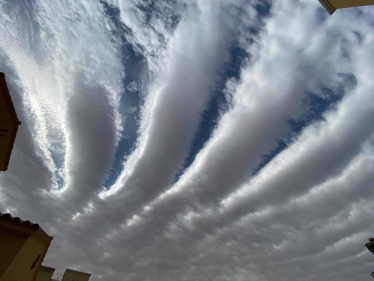 UAP where invisible waves are seen in a blue sky, like waves in a pond ...