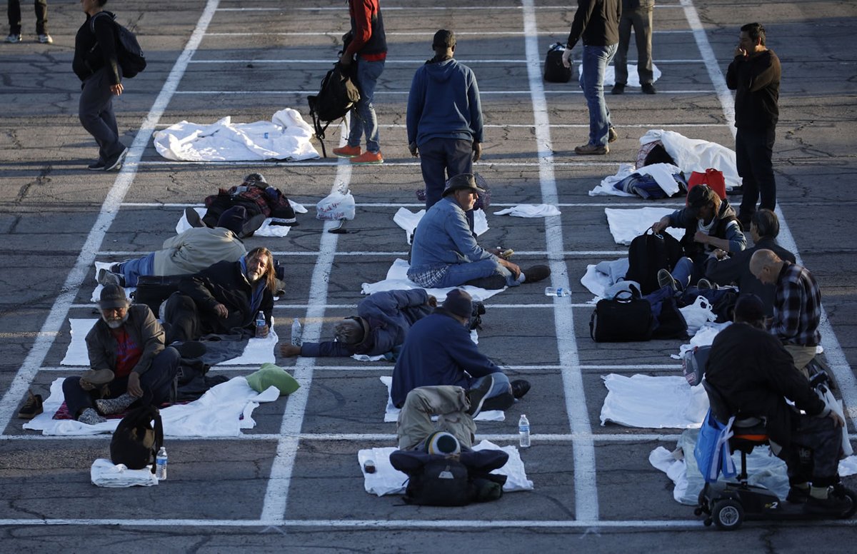 Jarring images show a crowd of homeless people sleeping in grids six ...