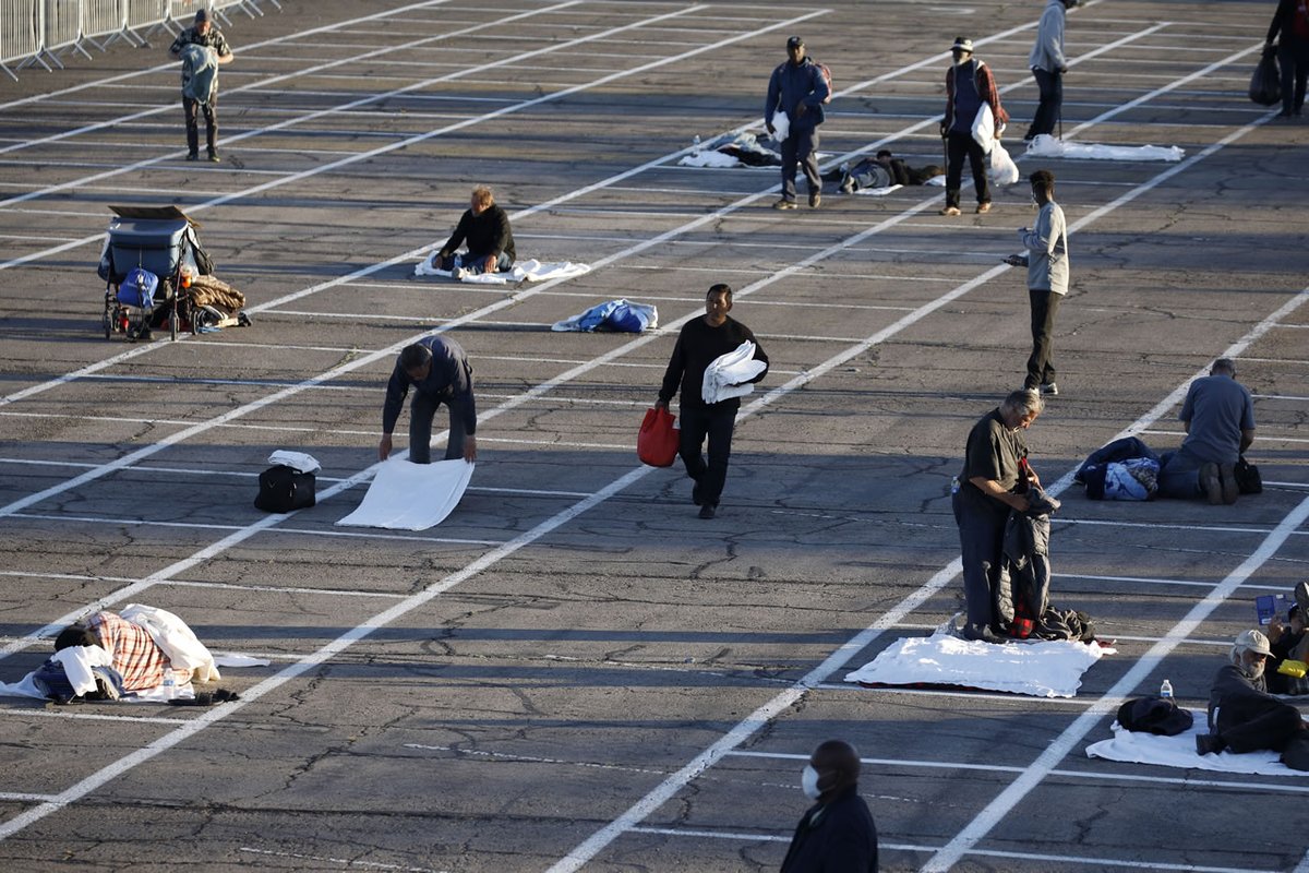 Jarring images show a crowd of homeless people sleeping in grids six ...