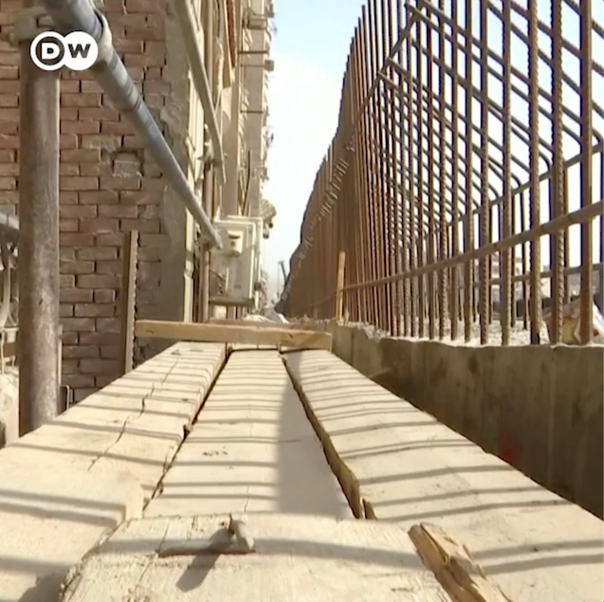 A new bridge in Cairo is being built so close to the apartment blocks ...