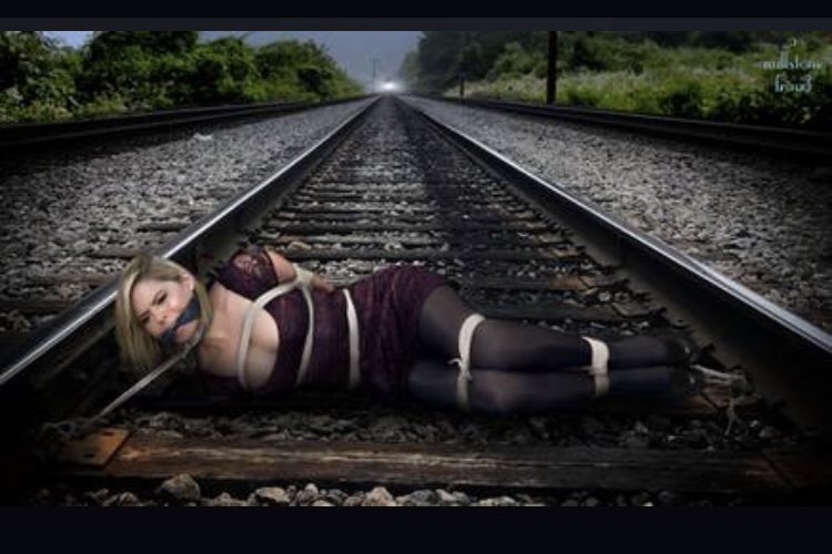 Woman Tied To Train Tracks