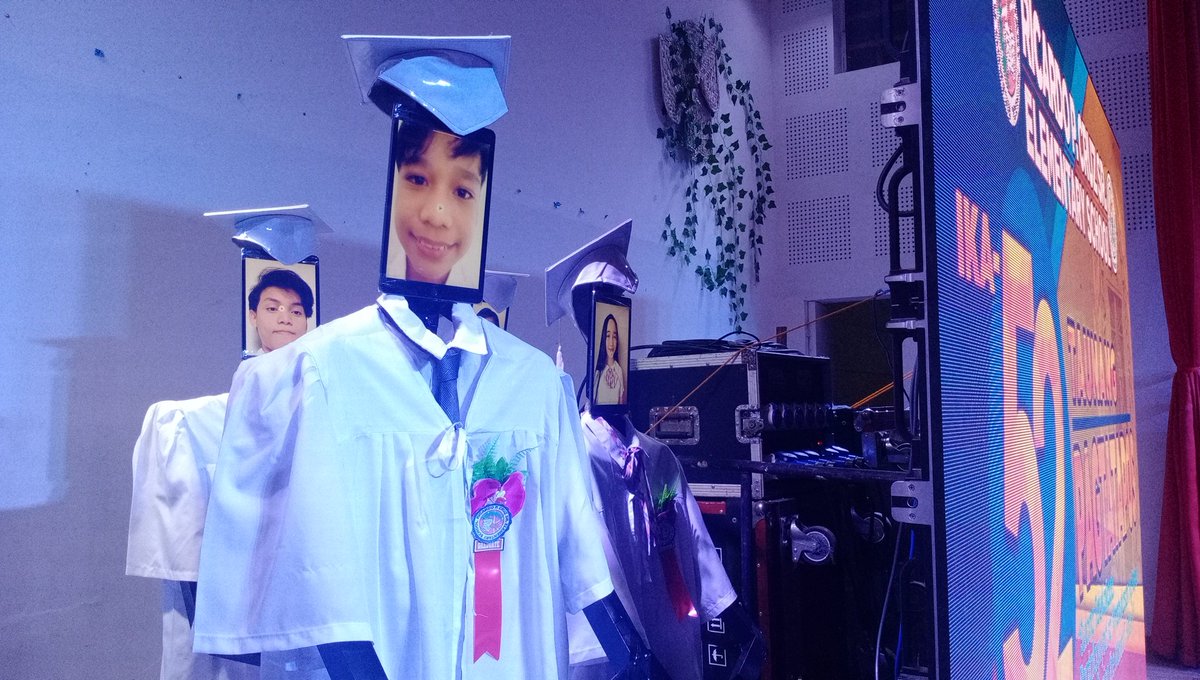 michael_delizo Toga-wearing robots receive the diplomas in behalf of ...