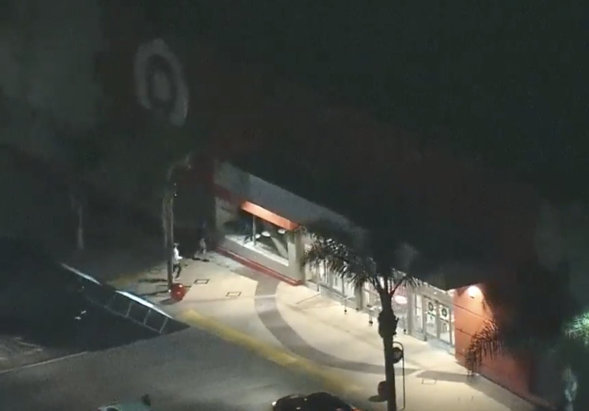 Looters now jumping through the broken window of a nearby Target on ...