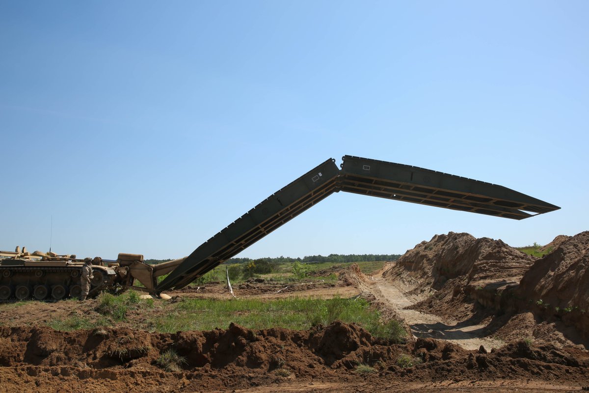 Soldiers maneuver an M1A Abrams Main Battle Tank across an Armored ...